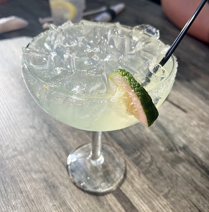 This isn't just a margarita – it's liquid sunshine with a lime smile, the perfect companion for seafood that tastes like the ocean's greatest hits.