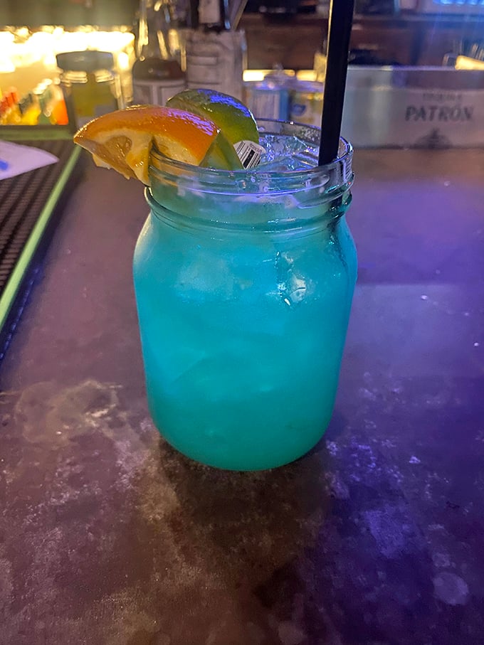 This electric blue cocktail in a mason jar isn't just a drink—it's a vacation in a glass, complete with citrus souvenirs.