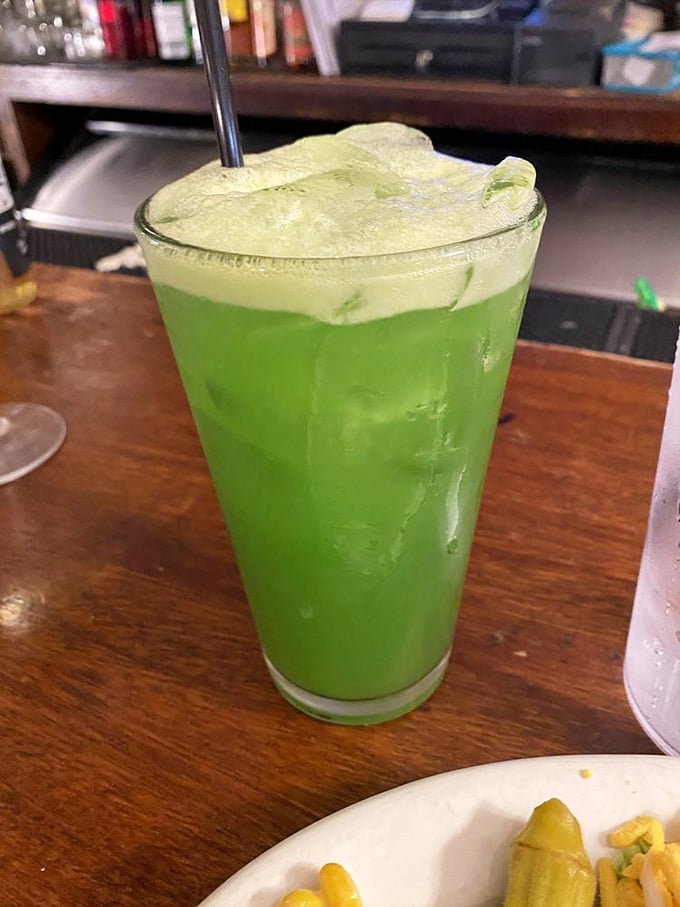 Electric green cocktail that looks like it could power a small city but goes down smoother than a jazz saxophone solo.