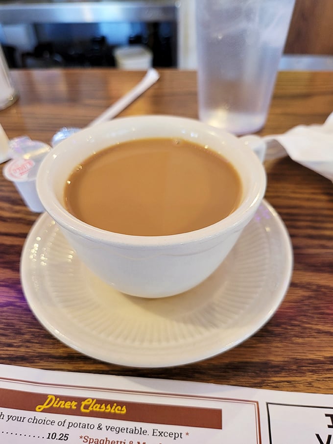 This isn't just coffee – it's liquid motivation in a classic white diner mug, ready to transform you into a functioning human.