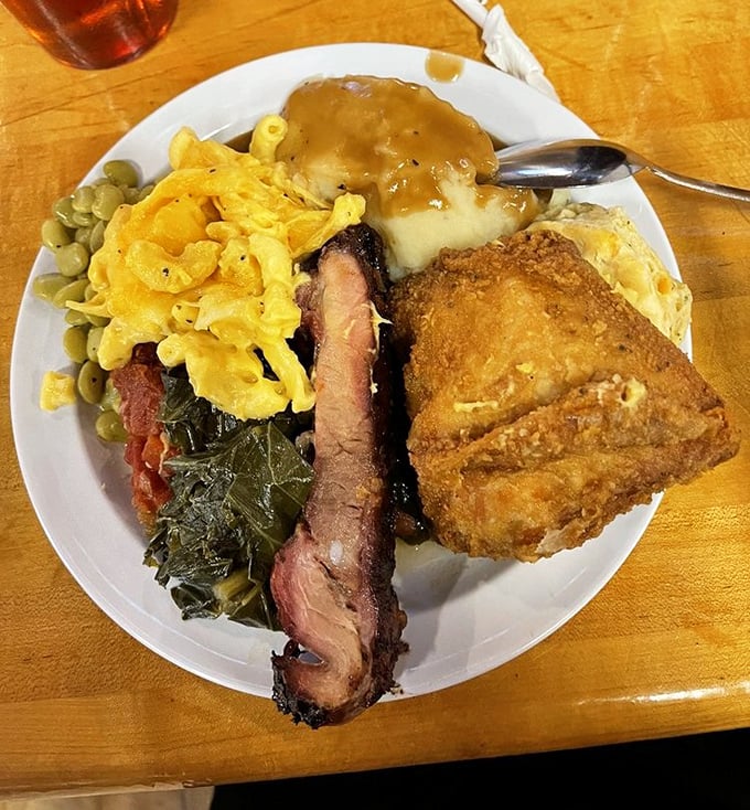 A plate that tells a story of smoke, spice, and everything nice—collards, mac and cheese, and fried chicken that makes you want to hug the cook.