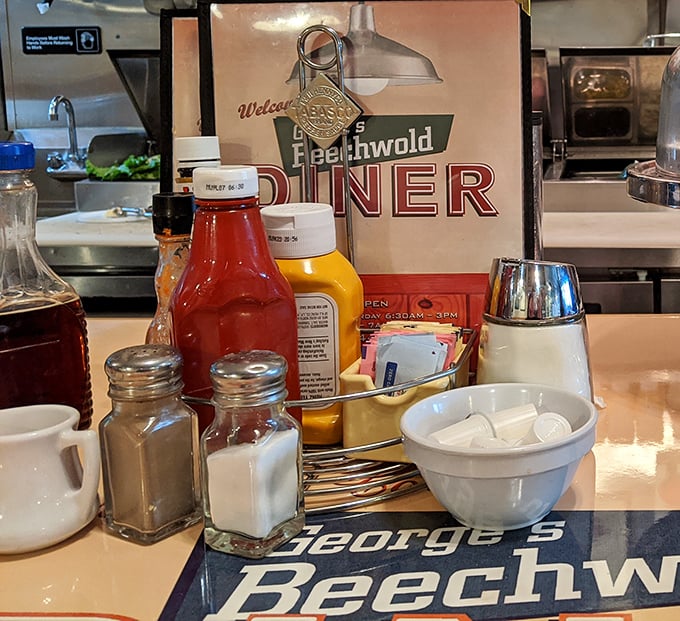 Table essentials arranged with military precision – salt, pepper, ketchup, and sugar packets standing at attention, ready for your culinary commands.