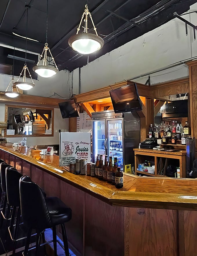 The bar area—where cold beer meets hot pizza in a romance as old as time itself. Wood paneling included at no extra charge.