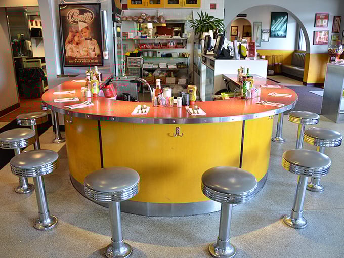 The circular counter with chrome stools isn't just seating—it's a social institution where strangers become temporary neighbors united by good food.
