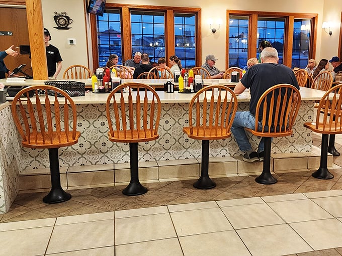 The counter seating – where solo diners become regulars, servers become friends, and coffee cups never reach empty before being refilled.