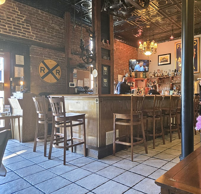 The bar area whispers stories of Prohibition while serving drinks that celebrate its end—vintage railway signs remind you this building has seen some things.