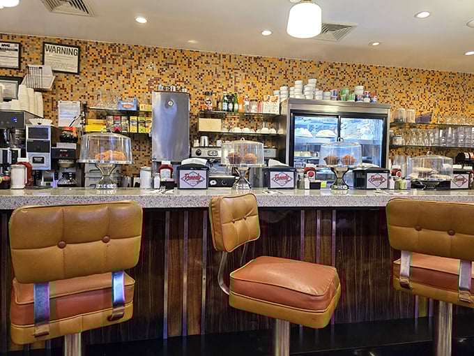 The counter seats—where solo diners become regulars, and the coffee refills flow as freely as the neighborhood gossip.