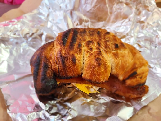 This isn't just a breakfast sandwich—it's morning salvation wrapped in a perfectly laminated croissant that shatters with buttery precision.