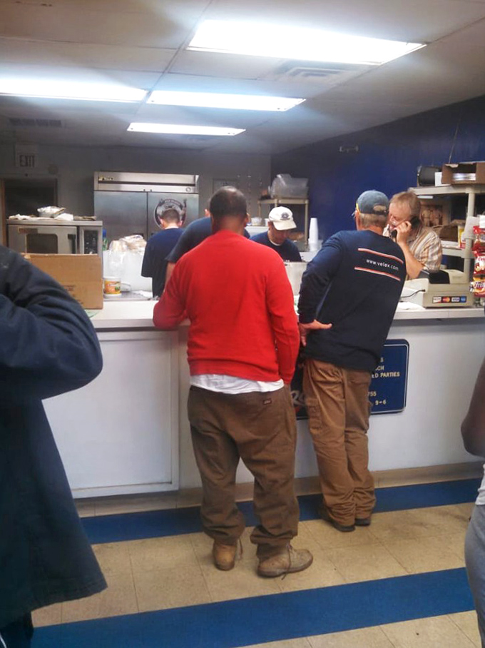 The lunchtime choreography – hungry customers patiently waiting their turn, knowing that sandwich perfection can't be rushed.