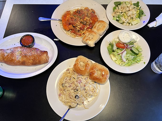 A feast fit for sharing – stromboli, pasta, and salads spread across the table like an Italian family reunion.