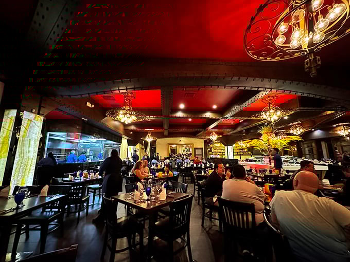 The restaurant buzzes with conversation under dramatic red ceilings. Everyone's united by the universal language of "pass the meat, please."