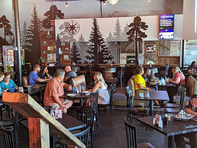 The forest mural creates a rustic backdrop for diners who've made the pilgrimage to this Cleveland gem – notice nobody's looking at their phones, just their plates.