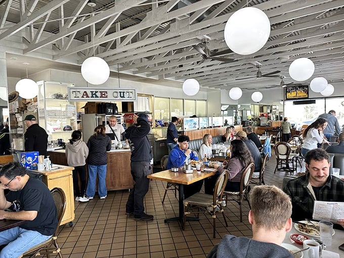 Where breakfast dreams come true—patrons gather at wooden tables while staff work their morning magic behind the counter.