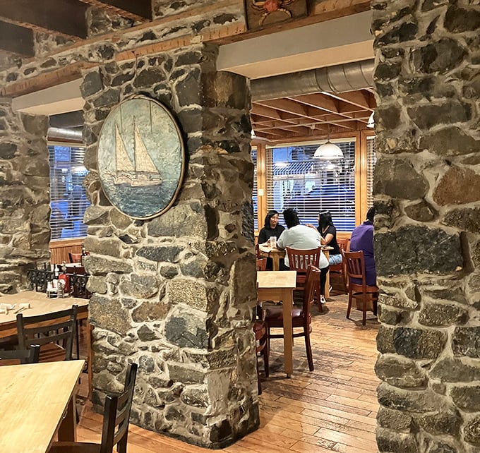 The dining room where stone walls tell stories of meals past. That sailboat painting isn't just decoration – it's a promise of the journey ahead.
