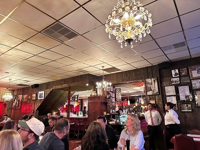 A packed house of happy diners under crystal chandeliers. Notice nobody's looking at their phones—that's the power of great food.