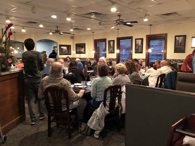 A bustling dining room filled with happy patrons – the universal language of "this place is worth the wait" spoken through a sea of satisfied smiles.