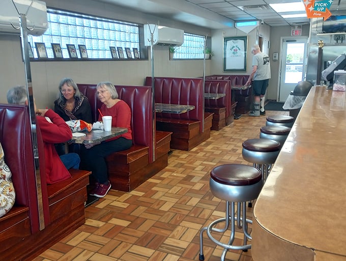 Regulars settle into booths worn smooth by decades of satisfied customers—these seats have heard more stories than a bartender.