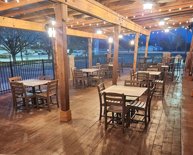 The outdoor dining area glows with string lights as evening falls, transforming a simple meal into an almost magical Kansas night experience.