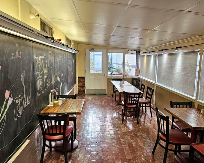 The dining area feels like your Danish grandmother's kitchen (if you had one)—brick floors, wooden tables, and a chalkboard that probably holds secrets to happiness.