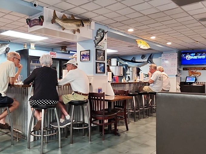 The counter seating – where regulars exchange fishing tales while waiting for their seafood fix. Notice nobody's looking at their phones.
