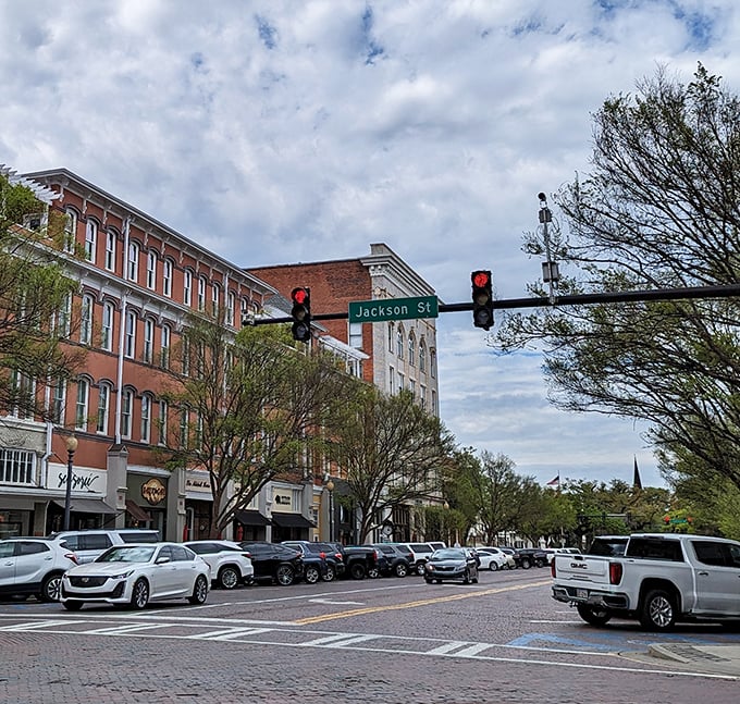 Broad Street buzzes with activity under Jackson Street's watchful traffic lights – the beating heart of Thomasville's vibrant downtown.