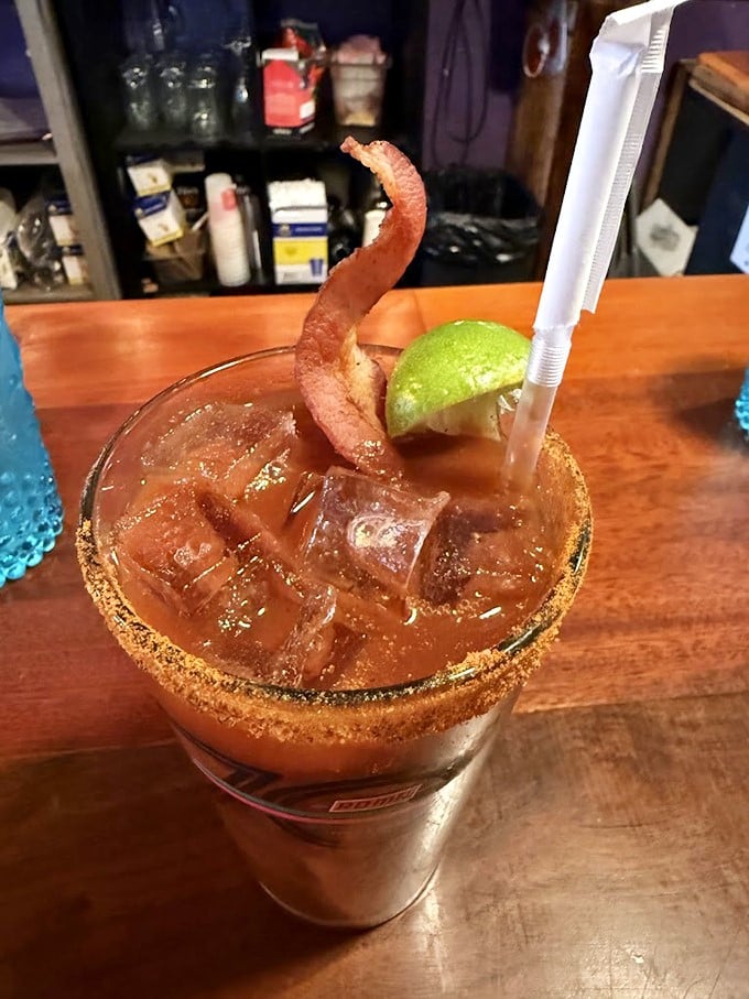 A Bloody Mary garnished with bacon—because drinking vegetables counts as healthy when there's meat involved. Breakfast of champions.