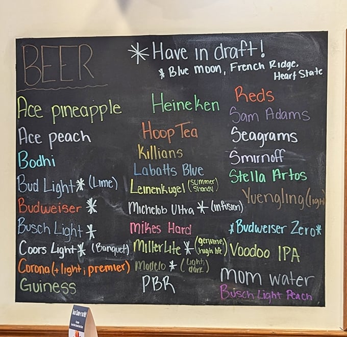 The drink menu chalkboard – where decisions get harder as the night gets longer. Local brews mingle with national favorites in colorful chalk harmony.