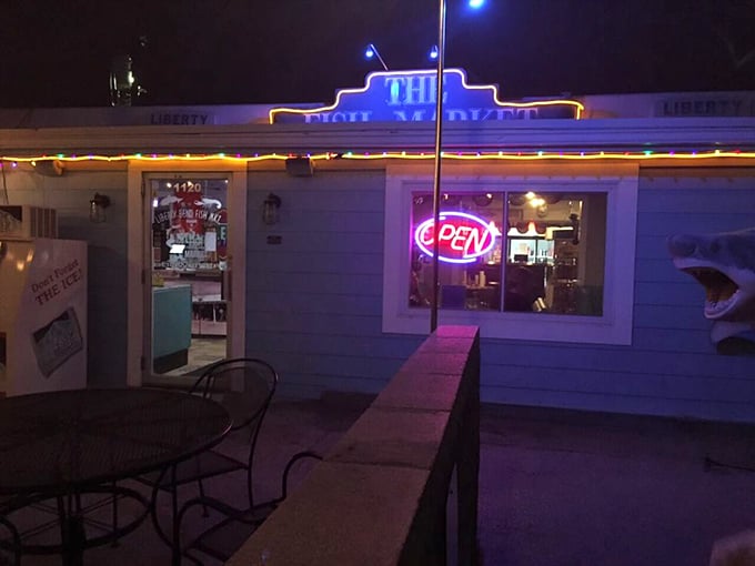 As night falls, the neon "OPEN" sign becomes a lighthouse for the seafood-starved, beckoning hungry travelers toward Cajun salvation.