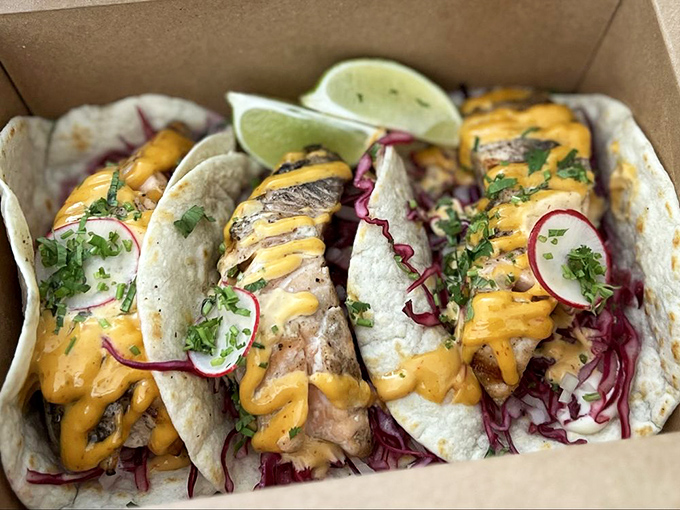 Fish tacos that bridge the gap between San Francisco and Baja—fresh, vibrant, and topped with enough sauce to require strategic eating techniques.