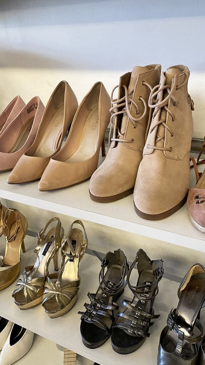 A lineup of barely-worn heels and boots that makes you wonder if Cinderella's fairy godmother moonlights as a donation coordinator.