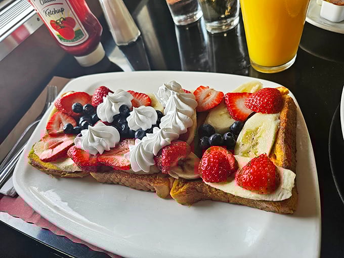 French toast that's crossed the line from breakfast to dessert, where fresh berries and whipped cream make you question why we ever settled for maple syrup alone.