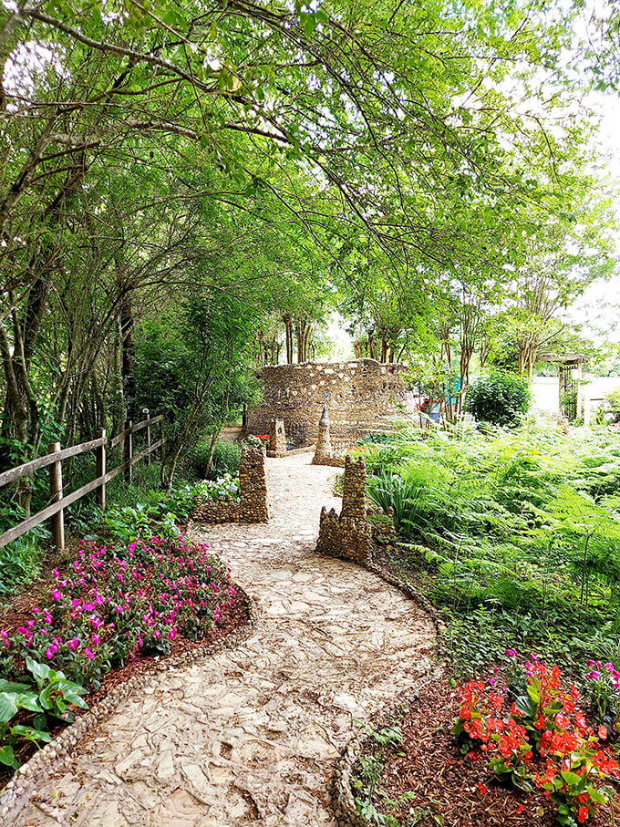 The winding path beckons visitors deeper into this stony wonderland, flanked by vibrant azaleas that seem to whisper, "You're not in ordinary Georgia anymore."