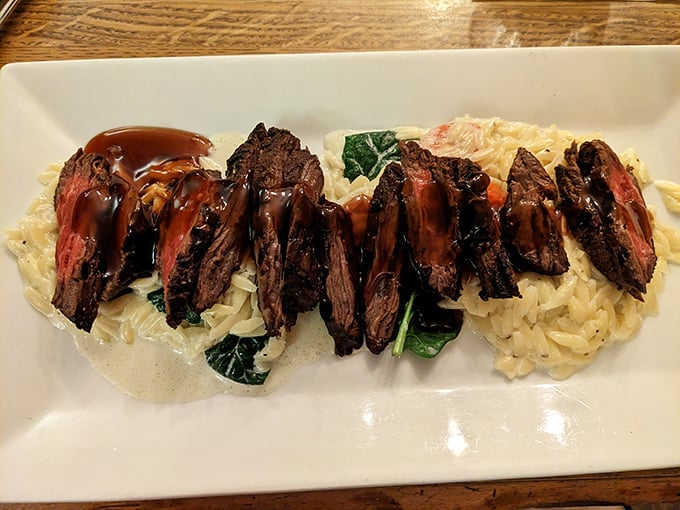 Steak sliced and served over risotto—because sometimes you want your protein and carbs to hold hands. That sauce is basically a flavor hug.