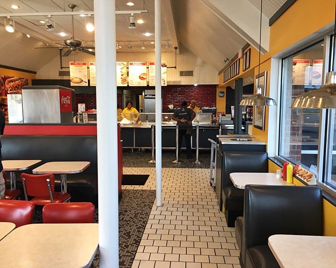 Where the magic happens—yellow walls, red booths, and the promise of comfort food that hasn't changed with the whims of culinary fashion.