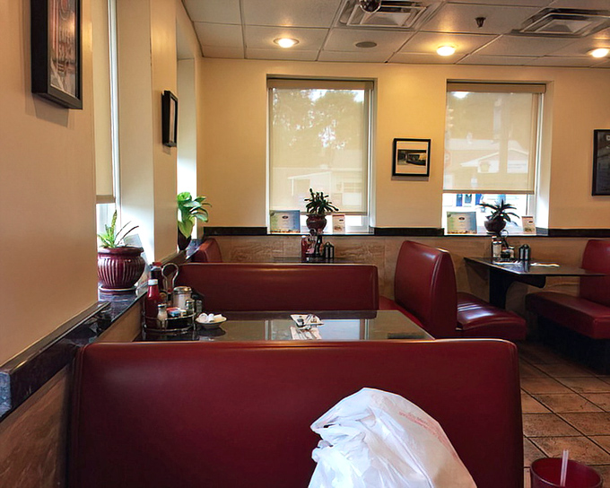 Sunlight streams through windows onto empty booths—the calm before the lunchtime storm in this neighborhood gathering place.