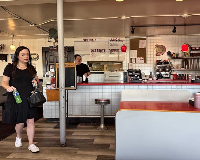 The counter and kitchen view—where the magic happens and servers move with the choreographed precision of Broadway dancers, but with better food.