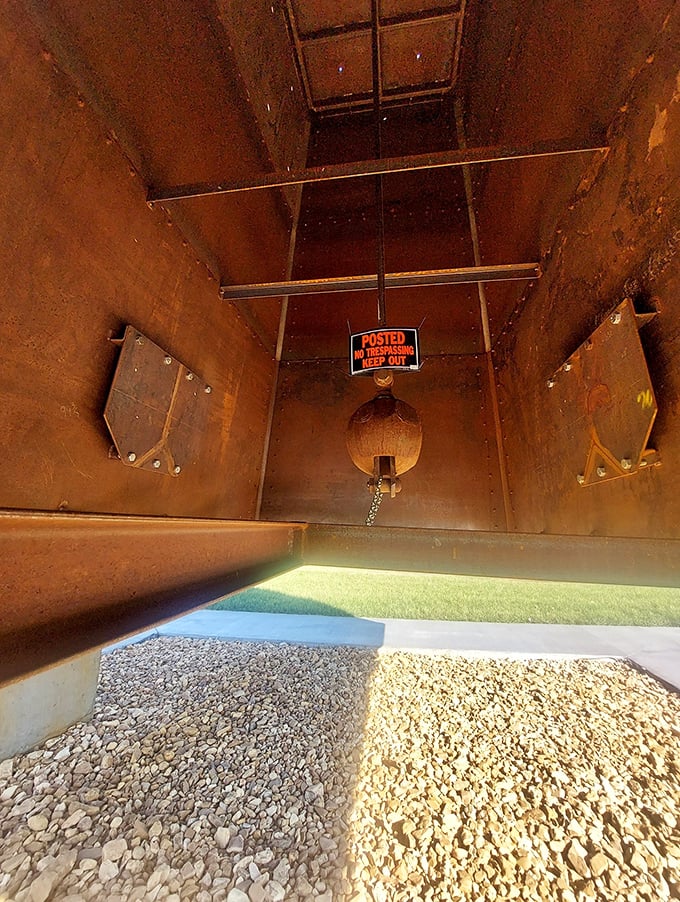 A peek inside reveals the internal structure and a warning sign for anyone tempted to climb.