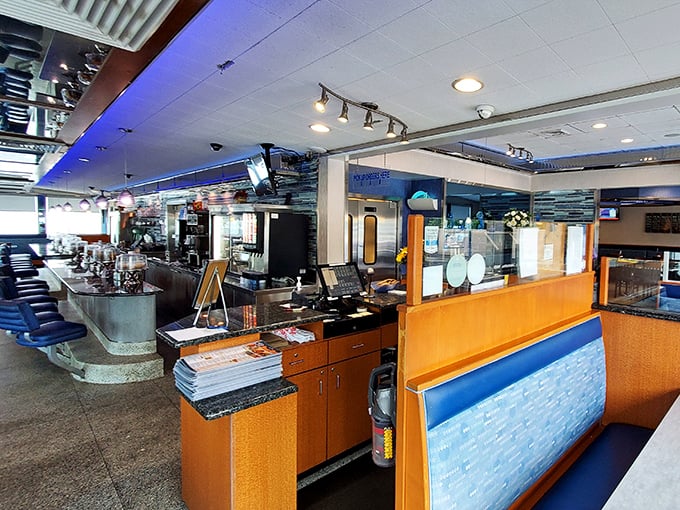 The counter and kitchen view – where diner magic happens. Blue accents and warm lighting create that unmistakable Pennsylvania diner atmosphere.