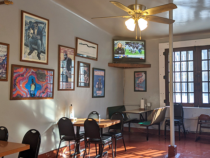 Railroad memorabilia adorns walls bathed in natural light—a dining room where conversations flow as easily as the barbecue sauce.