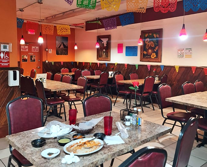 The dining area's papel picado banners add festive pops of color overhead, creating a perpetual celebration of Mexican culture with every meal.