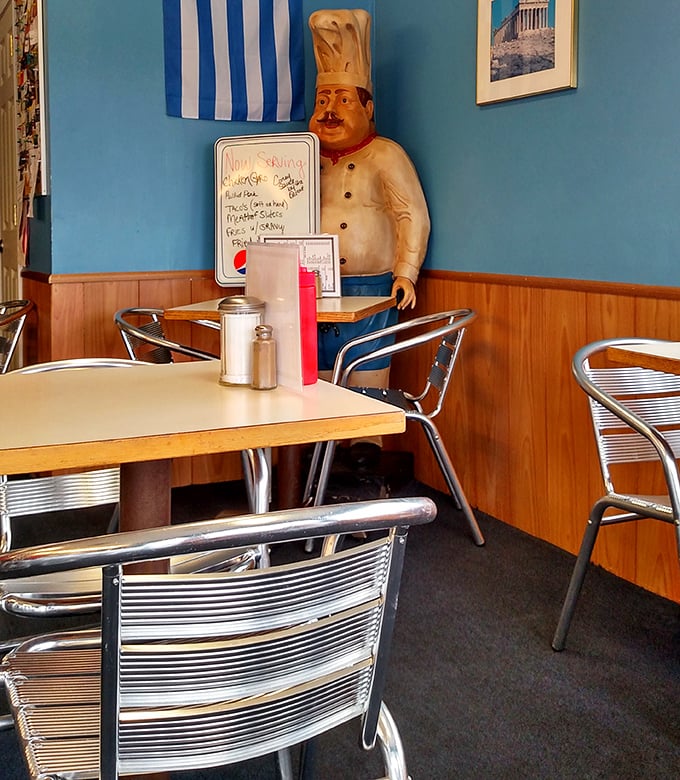 The chef statue stands guard like a sentinel of flavor, silently promising that yes, you've come to the right place for authentic Greek-American goodness.
