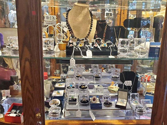 Behind glass doors, jewelry waits for second chances at love stories—each gemstone holding secrets of anniversaries and proposals past.