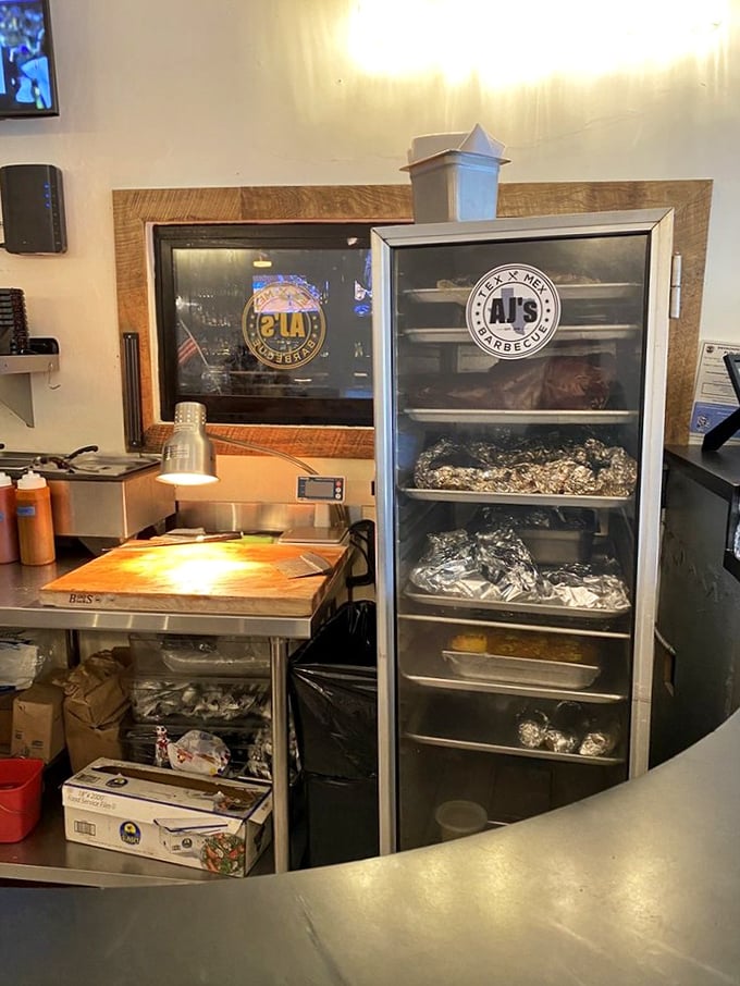 A barbecue station that doesn’t overcomplicate things—just foil-wrapped treasures waiting their turn, with a cutting board standing by to seal the deal.