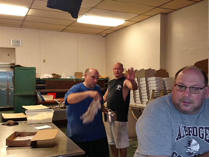 Behind the scenes where the magic happens. No fancy equipment, just decades of pizza-making wisdom passed down through generations.