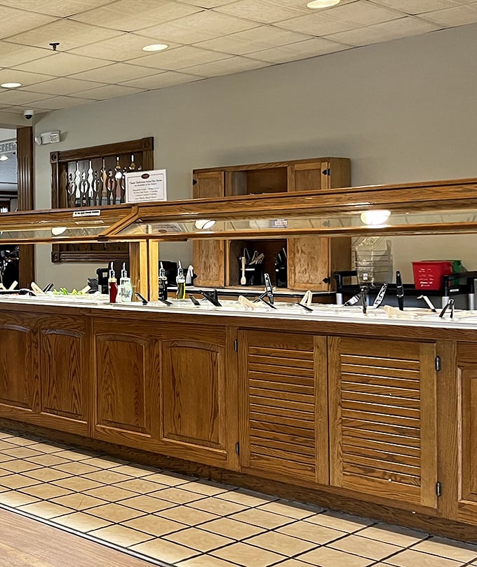 The buffet line stands ready for action, like a culinary starting gate where everyone wins. Those wooden serving stations have seen generations of hungry visitors.