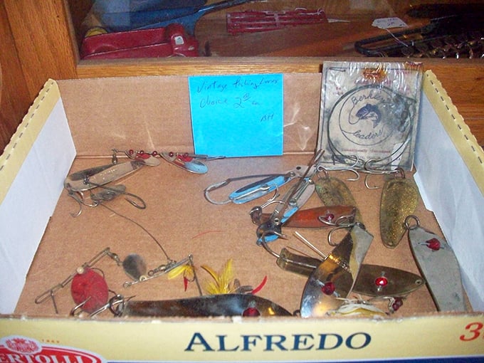 Fishing lures nestled in their makeshift Alfredo pasta box home. Each one designed to catch fish—but today they've caught your attention instead.