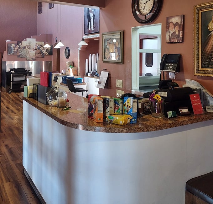 The front counter tells stories without words—family photos, religious art, and the quiet efficiency of a restaurant that knows its purpose.