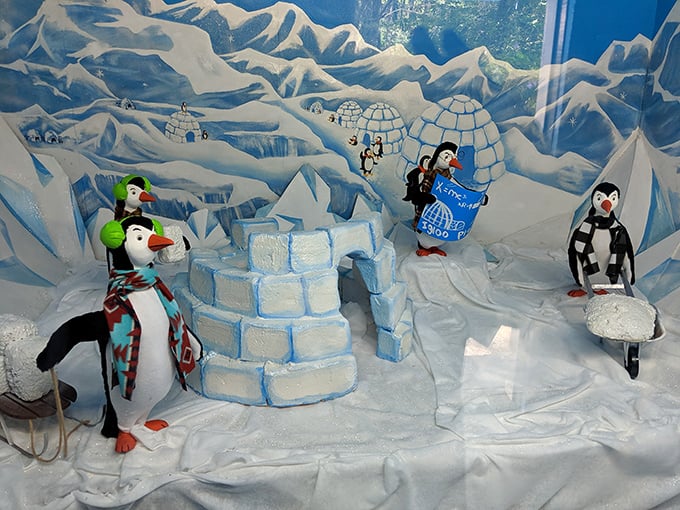 These cheerful penguins building igloos capture that retro roadside attraction charm perfectly—kitschy, delightful, utterly sincere about it.