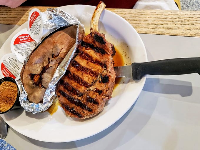 This pork chop with its perfect grill marks is like edible sheet music—each stripe representing a note in a symphony of flavor.