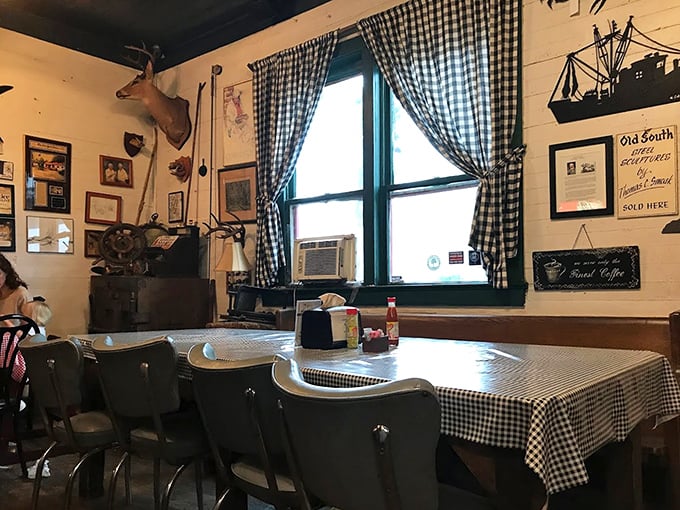 Mounted deer heads watch over diners like guardians of Southern tradition. The checkered tablecloths aren't ironic—they're authentic.